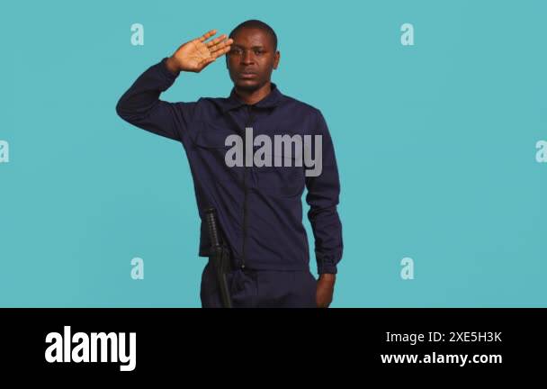 Security guard doing salute hand gesture, preparing to start job of ...