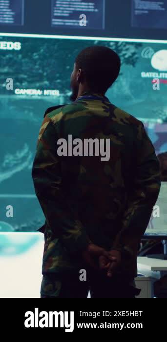 Vertical Video Staff sergeant monitoring satellite live imagery on a ...