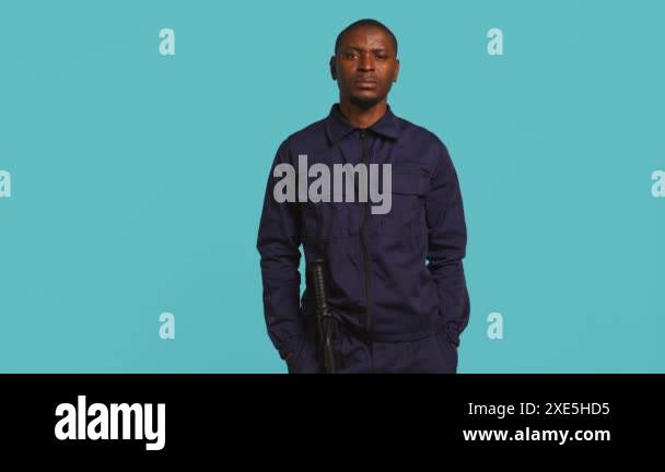 Smiling security guard saluting people during surveillance shift ...