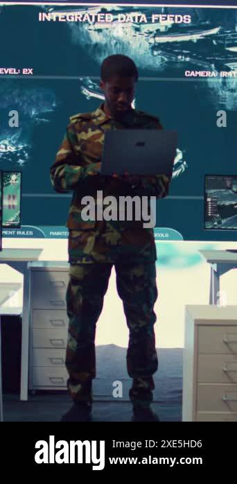 Vertical Video Infantry unit leader examines big data on a screen in ...