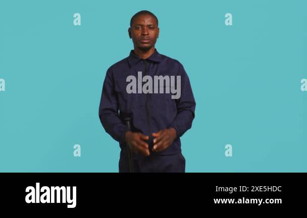 Security guard doing pretending to shoot gun hand gesture while being ...