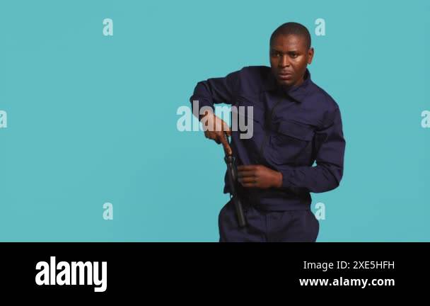 Security guard turning on flashlight and preparing baton to detect and ...