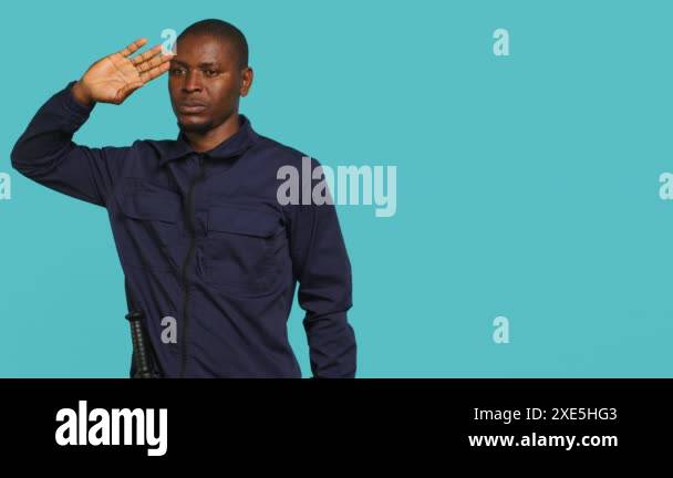Security guard doing salute hand gesture, preparing to start job of ...