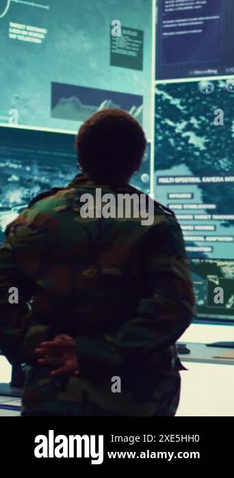 Vertical Video Woman army officer coordinating special operations mission in command post ...