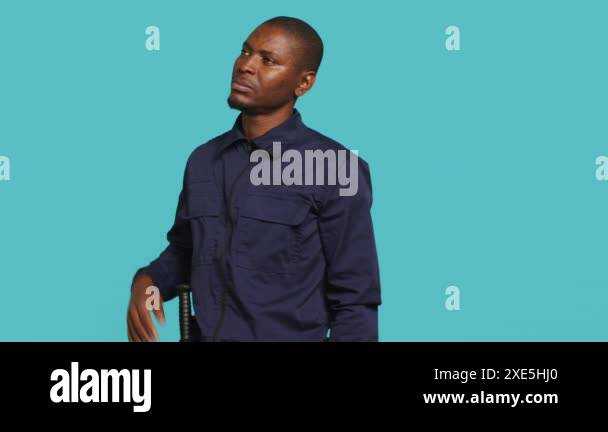 Security guard doing thinking hand gesture during surveillance shift ...