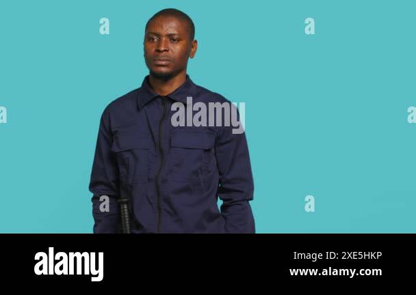 Smiling security guard saluting people during surveillance shift ...