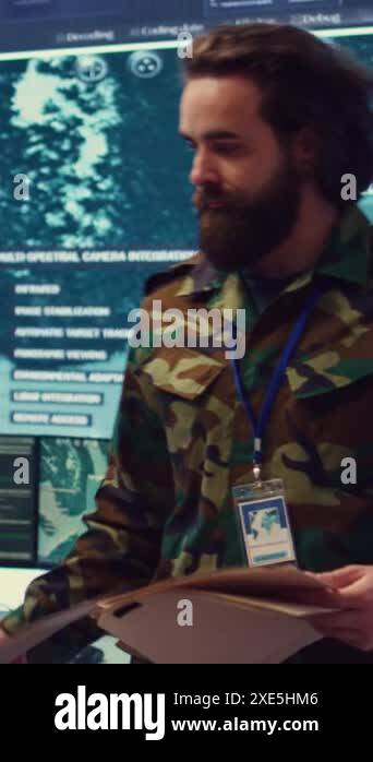 Vertical Video Staff sergeant providing mission files to brief his operational crew, working on ...