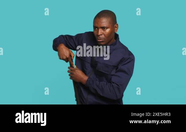 Security guard turning on flashlight and preparing baton to detect and ...