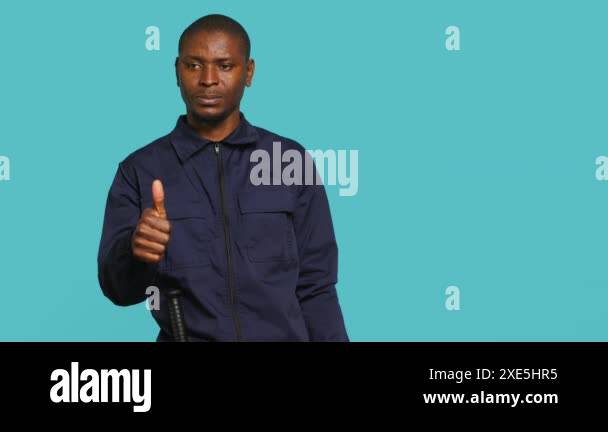 Happy security guard doing thumbs up sign gesturing with finger ...