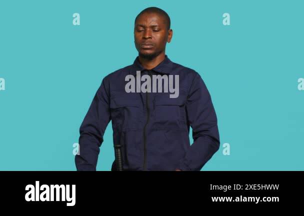 Security guard in threatening pose, tasked with preventing criminal ...