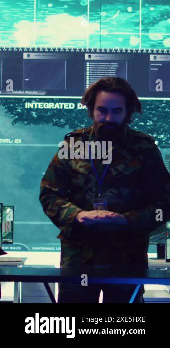 Vertical Video Army officers review data on a hologram to create a ...