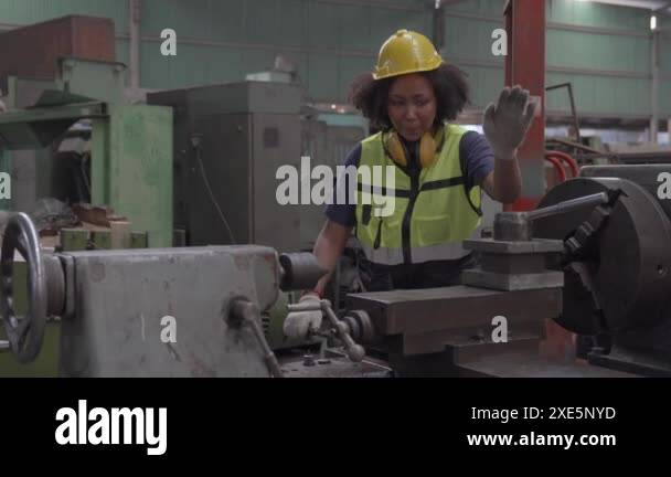 Manufacturing worker. African american mechanical engineer operating ...