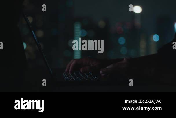Night hours person illuminated by soft glow computer screen coding programming typing keyboard ...
