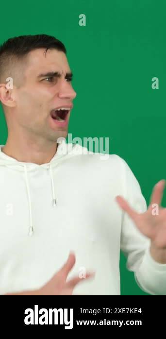 emotions of a handsome man guy on a green background chromakey close-up ...