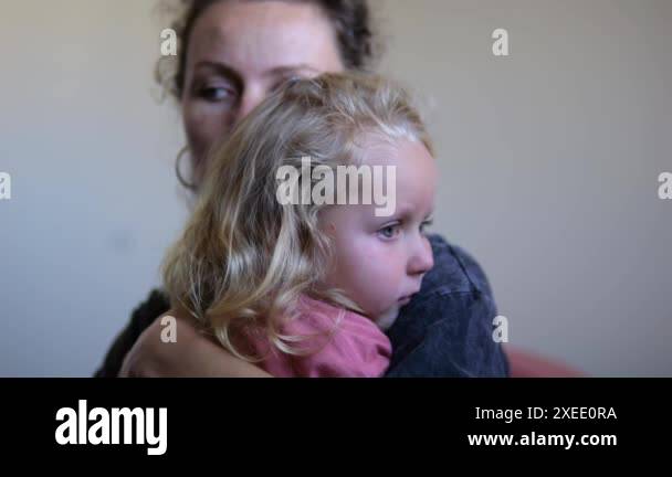 Loving mother hugs and comfort little upset daughter. Comfort child is ...