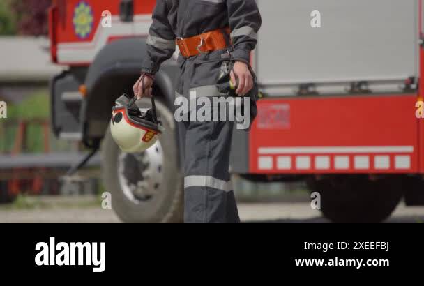 A special firefighter stands beside a firetruck, poised and ready for a ...