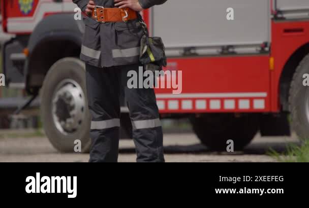 A special firefighter stands beside a firetruck, poised and ready for a ...