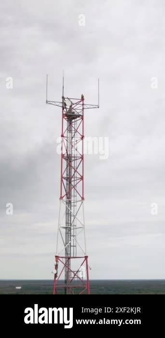 Vertical video. Mobile receiver and transmitter antenna tower, antenna tower building with the ...
