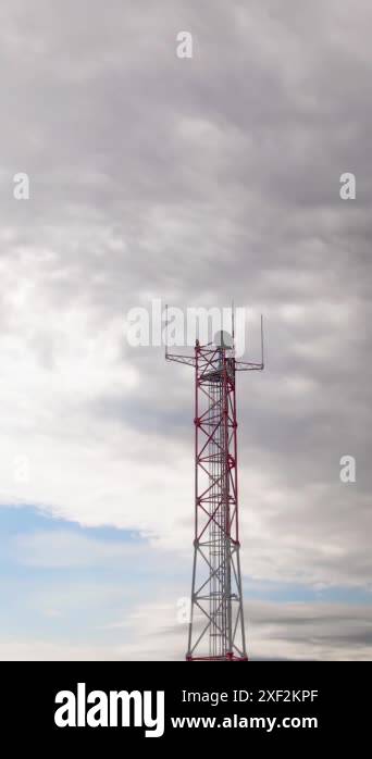 Vertical video. Mobile receiver and transmitter antenna tower, antenna tower building with the ...