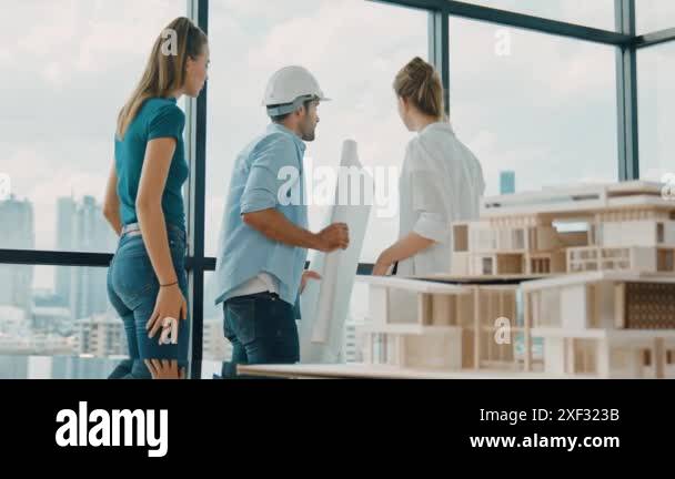 Smart architect engineer team in casual outfit talking while look at ...