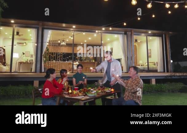 Happy family holding glowing sparkler in holiday celebration party at ...