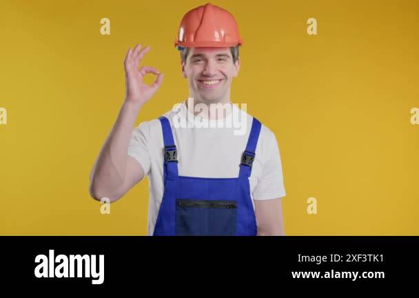 Positive american handyman makes hand sign OK, okay gesture. Happy ...