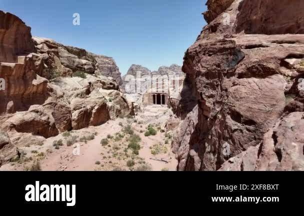 Walking on a narrow path between high sandstone cliffs leading to the ...