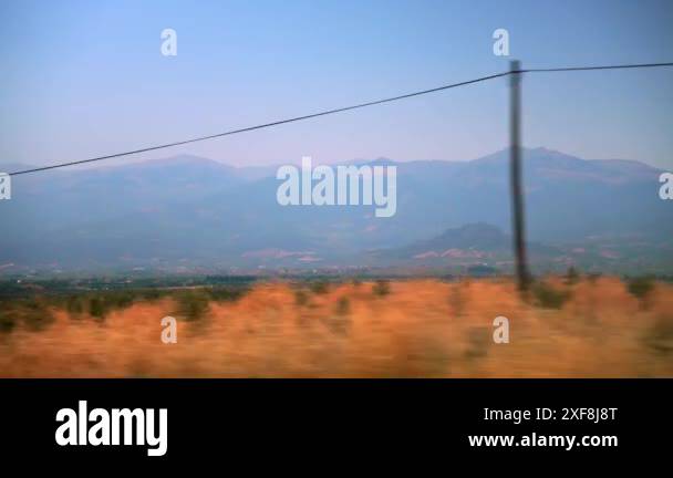 rolling countryside with expansive green fields leading up to a distant ...