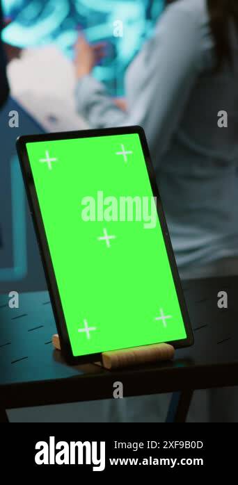 Vertical video Green screen tablet used by computer scientists in ...