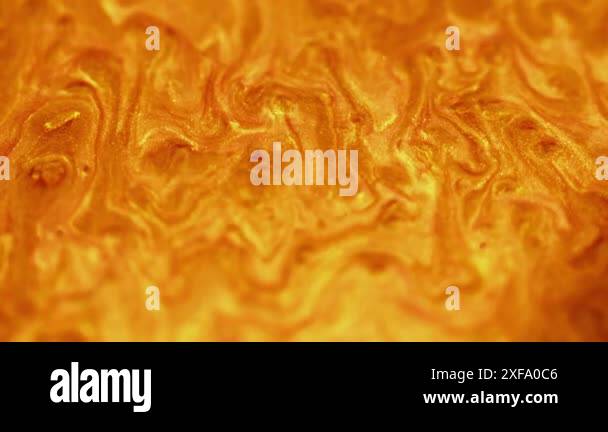 Glitter fluid drip. Sparkling paint spill. Defocused gold yellow color ...