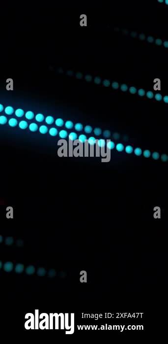 Stream of glowing lines from dots. Motion. Bright stream of binary neon lines on black ...