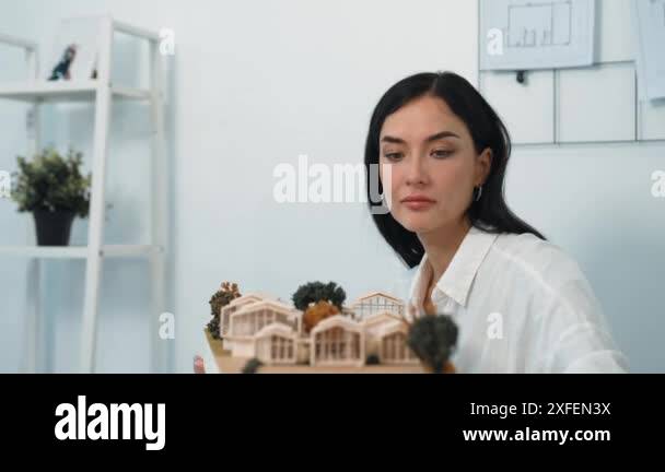 Close up of skilled young beautiful caucasian architect lift house ...