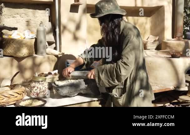 Mexican young gril trying to make nixtamal the traditional mexican way ...