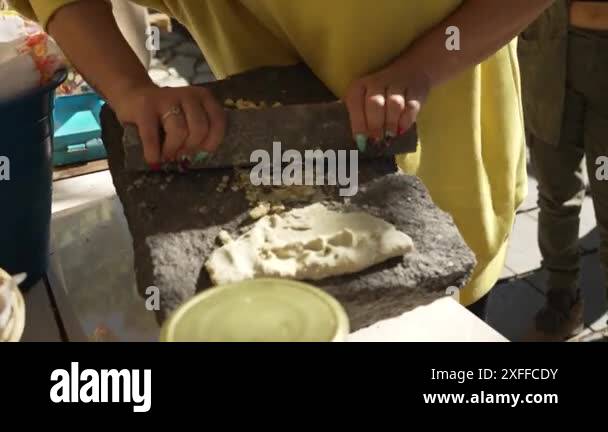 Close up young fancy girl trying to make nixtamal for tortillas, the ...