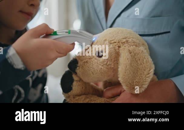 Kid measuring temperature toy at home closeup. Little child holding ...