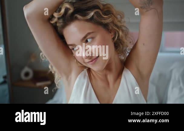 Smiling model stretching in morning at home closeup. Beautiful serene ...
