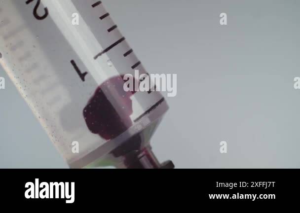 Extreme close-up drawing in blood into syringe. Macro shot medical ...