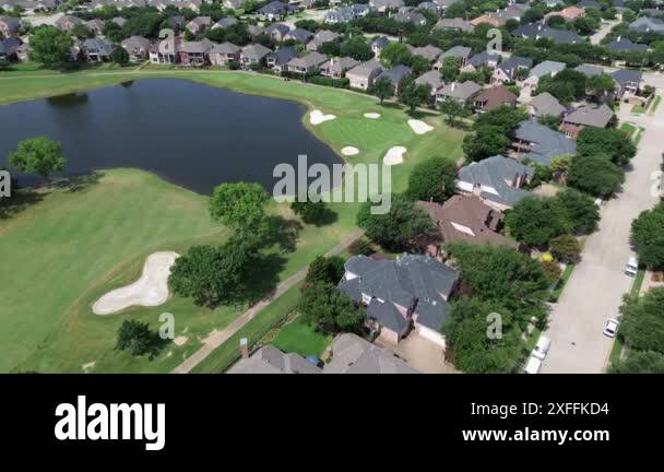 Golf course pond with golfer playing, club cars moving in upscale ...