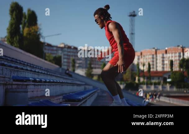 Slow motion. Jumping training of a male athlete on the steps of the ...