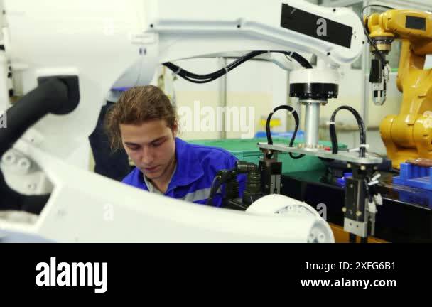Male robot engineers worker working in a team checking the robot arm ...