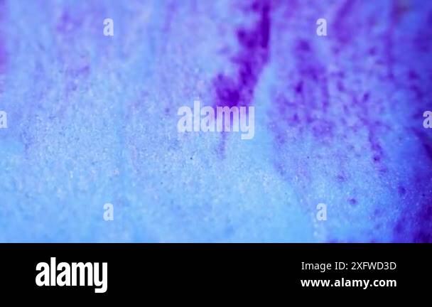 Sequin paint mix. Ink spill. Sparkling fluid. Defocused blue purple ...