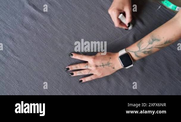 Top view of a woman hands as a professional tailor in an atelier ...