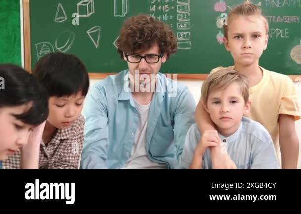 Teacher and multicultural student looking at laptop while celebrate success project and put ...