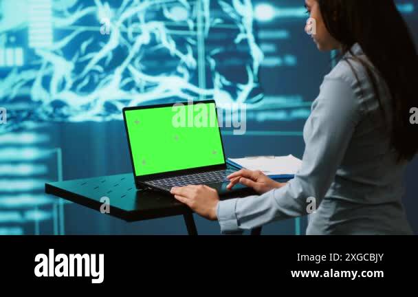 Startup employee looking over charts, using AI software on green screen ...