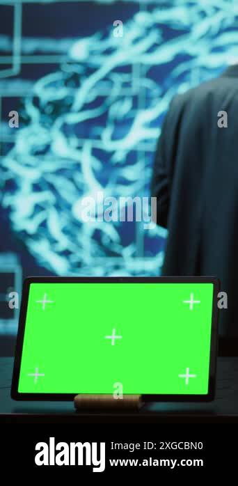 Vertical video AI programmers colleagues using green screen laptop for business data analysis ...