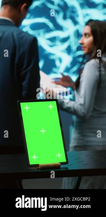 Vertical video Engineers use green screen tablet and AI neural networks modeled after human ...