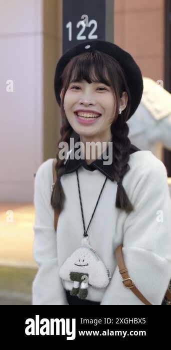 Vertical slow-motion video of a young and cute Taiwanese woman in her ...