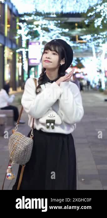 Vertical slow-motion video of a young and cute Taiwanese woman in her ...