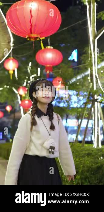 Vertical slow-motion video of a young and cute Taiwanese woman in her ...