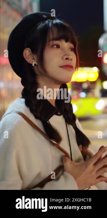 Vertical slow-motion video of a young and cute Taiwanese woman in her ...